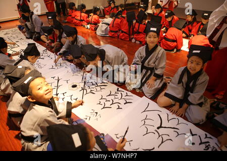 Students write the Chinese character "Ren," meaning "Human" in English ...