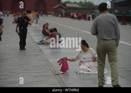 Chinese visitors lie on the Danbi Bridge in the Temple of Heaven Park ...