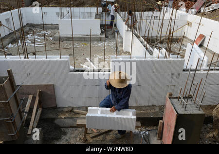 Chinese workers use expanded Polystyrene (EPS) foam to build houses in ...