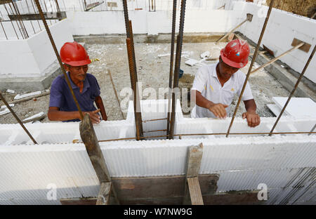 Chinese workers use expanded Polystyrene (EPS) foam to build houses in ...
