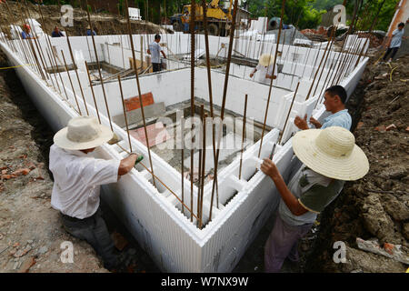 Chinese workers use expanded Polystyrene (EPS) foam to build houses in ...