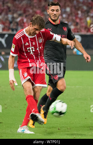 Thomas Muller of Bayern Munich kicks the ball to shoot against Arsenal ...