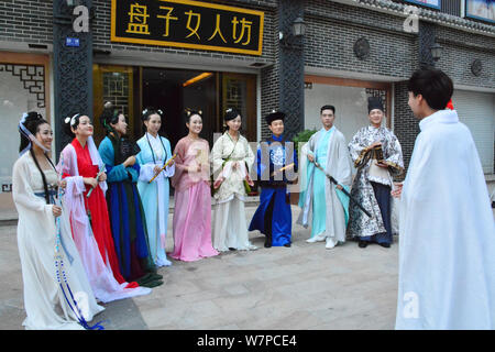 Chinese employees dressed in traditional costumes are on the way to go ...