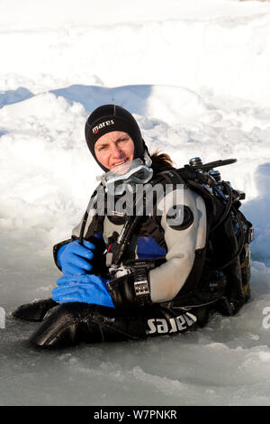 scuba diver sitting on the ice hole Stock Photo - Alamy
