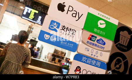 --FILE--A signboard of payments through Apple Pay, Alipay of Alibaba ...