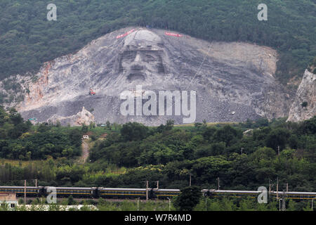 A sculpture of Fuxi, a culture hero in Chinese legends, is being carved ...