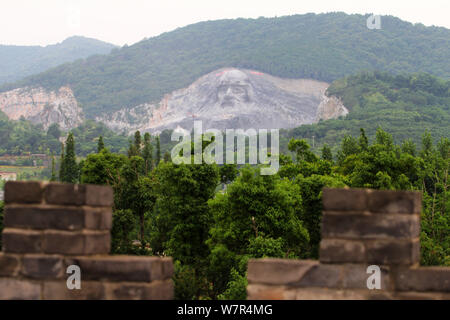A sculpture of Fuxi, a culture hero in Chinese legends, is being carved ...