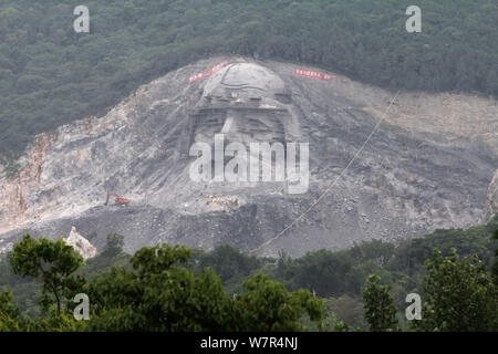 A sculpture of Fuxi, a culture hero in Chinese legends, is being carved ...