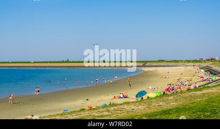 The beach of tholen with visitors, popular beach in zeeland, Bergse ...