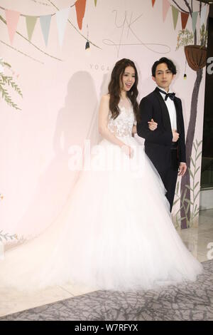Taiwanese singers Yoga Lin, right, and Kiki Ting attend their wedding ...