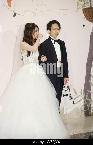 Taiwanese singers Yoga Lin, right, and Kiki Ting attend their wedding ...