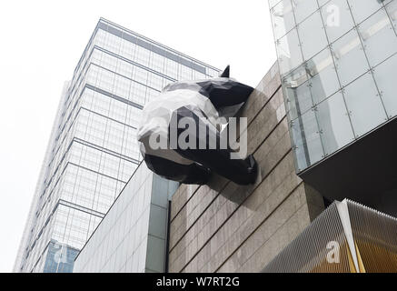 A giant panda sculpture climbs the building of the Chengdu ...