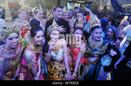 Thai actor Nawat Kulrattanarak, center, better known by his stage name ...