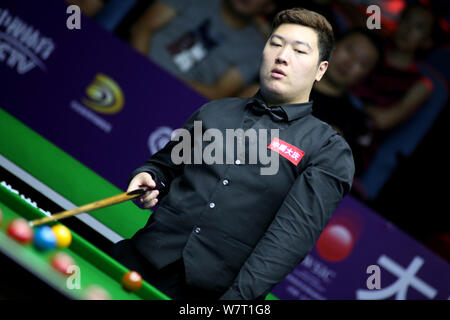 Yan Bingtao of China considers a shot to Shaun Murphy of England in the ...