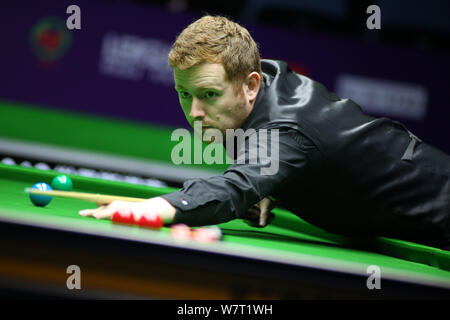 Mark Anthony Selby of England plays a shot to Ben Woollaston of England ...
