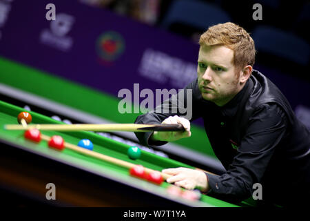 Mark Anthony Selby of England plays a shot to Ben Woollaston of England ...