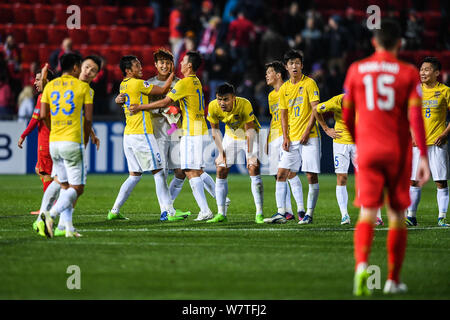 Players of Jiangsu Suning F.C. celebrate after scoring a goal against ...
