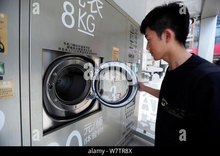 A customer uses a public washing machine installed outside a mall in ...