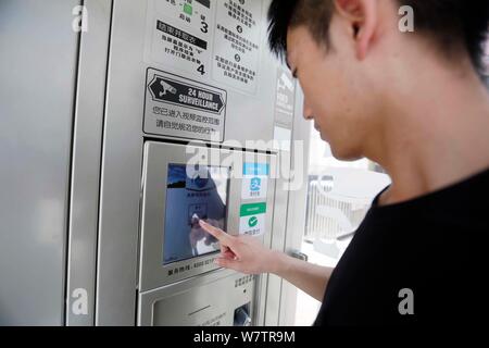 A customer uses a public washing machine installed outside a mall in ...