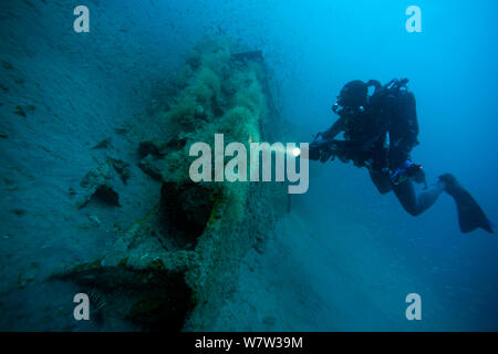 Diver on the wreck the US Submarine tender USS Macaw sunk in the World ...