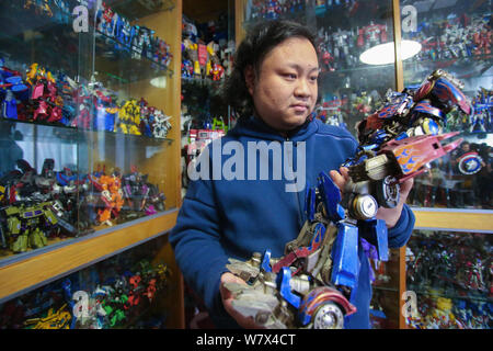 Chinese Transformers fan Wang Geng shows a poster of the movie ...