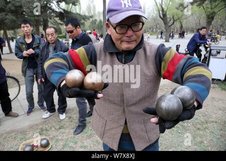 61-year-old Chinese man Piao Yingmin shows his iron balls at a park in ...