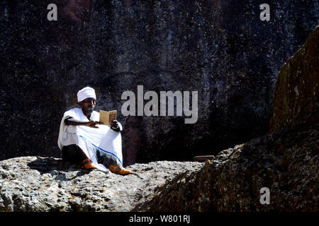 Devout Christian in traditional robes studying at Bet Medhane Alem ...