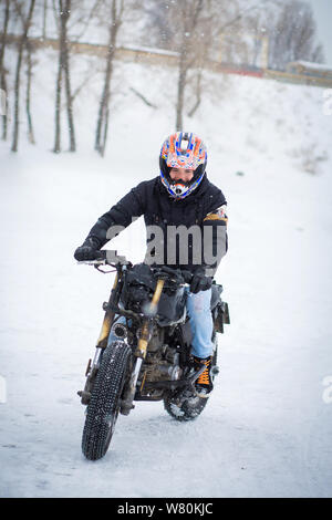 A guy rides a motorcycle on a frozen lake Stock Photo - Alamy