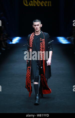 Chinese fencer Dong Li displays a new creation at the fashion show of ...