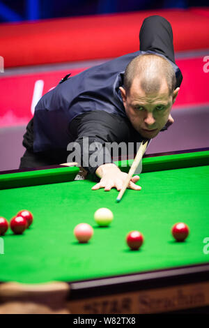 Ryan Day of Wales plays a shot to Ding Junhui of China in their first ...