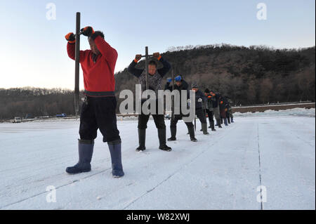 Workers collect ice blocks in Jiangbin Park to build an ice and snow ...