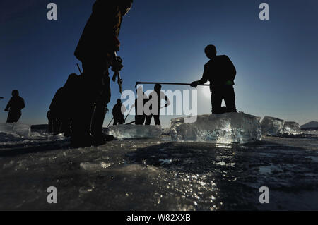 Workers collect ice blocks in Jiangbin Park to build an ice and snow ...