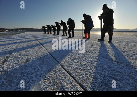 Workers collect ice blocks in Jiangbin Park to build an ice and snow ...