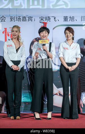 Chinese actress Yan Ni, left, and actor Zhao Lixin pose as they arrive on the red carpet for the ...