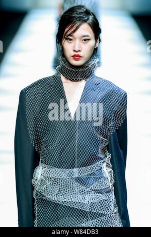 A model displays a new creation of the Spring/Summer 2015 Mashama X ShanghaiTang, Alex Wang X ...