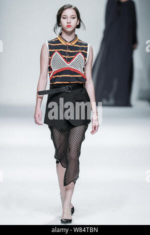 A model displays a new creation of the Spring/Summer 2015 Mashama X ShanghaiTang, Alex Wang X ...