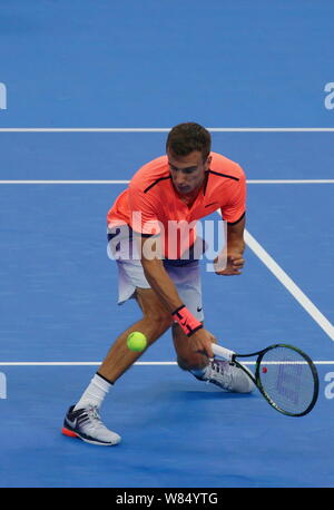 Andrei Kuznetsov of Russia returns a shot to Andy Murray of Britain in ...