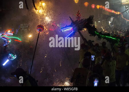 Chinese entertainers perform a fire dragon dance to celebrate the Mid ...