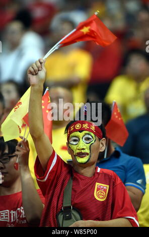 Chinese football fans wave national flags and shout slogans to show ...
