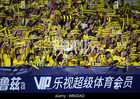Fans shout and hold banners to show support to Malaysia's Johor Darul ...