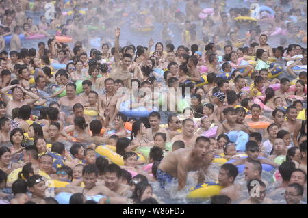Chinese holidaymakers crowd a swimming pool at a water park in Nanchang ...