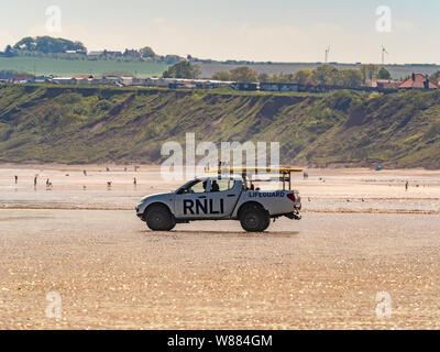 Rnli Patrol on beach at filey North Yorkshire Stock Photo - Alamy