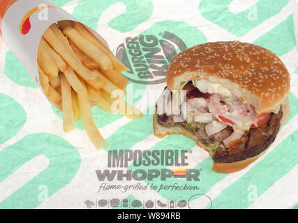 Whopper burger and chips or fries from Burger King on white plate on ...