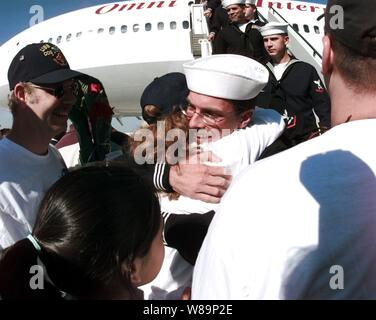Crew members of the repair ship USS VULCAN (AR-5) bow their heads ...