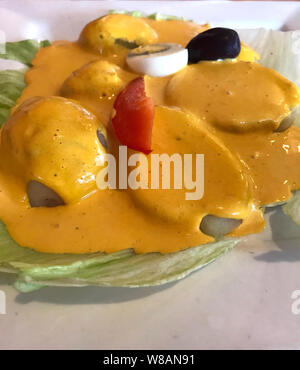 Traditional Peruvian papa a la huancaina on gray stone background Stock ...