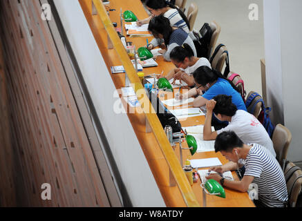 Chinese students review textbooks or write test papers to prepare for ...