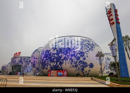 People walk past the Wanda Mall at the Nanchang Wanda Cultural Tourism ...