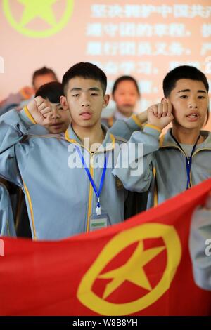 --FILE--Young Chinese students swear in during a ceremony for becoming ...