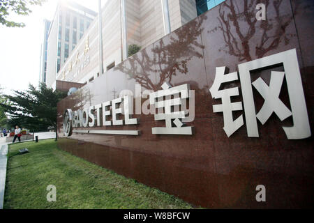 --FILE--A pedestrian walks past the Baosteel Tower in Shanghai, China ...