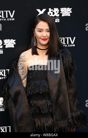 Chinese singer Tan Weiwei arrives for a premiere event of the movie "X ...